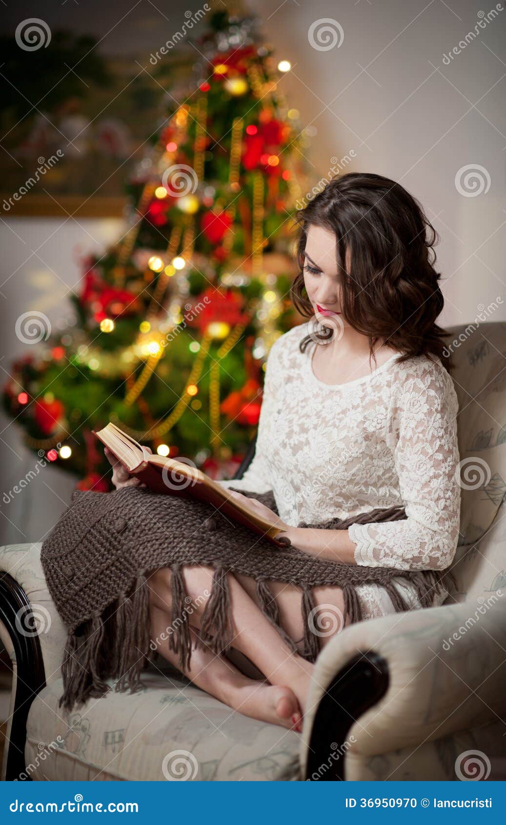 Beautiful Sexy Woman With Xmas Tree In Background Reading A Book