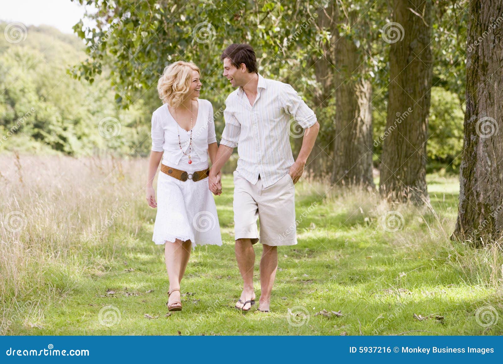 Couple Walking On Path Holding Hands Smiling Royalty Free Stock Image