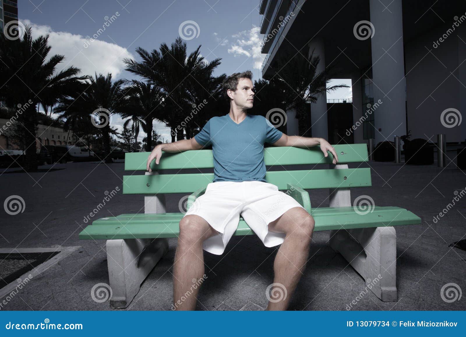 Man Sitting On A Bus Bench Stock Images Image 13079734