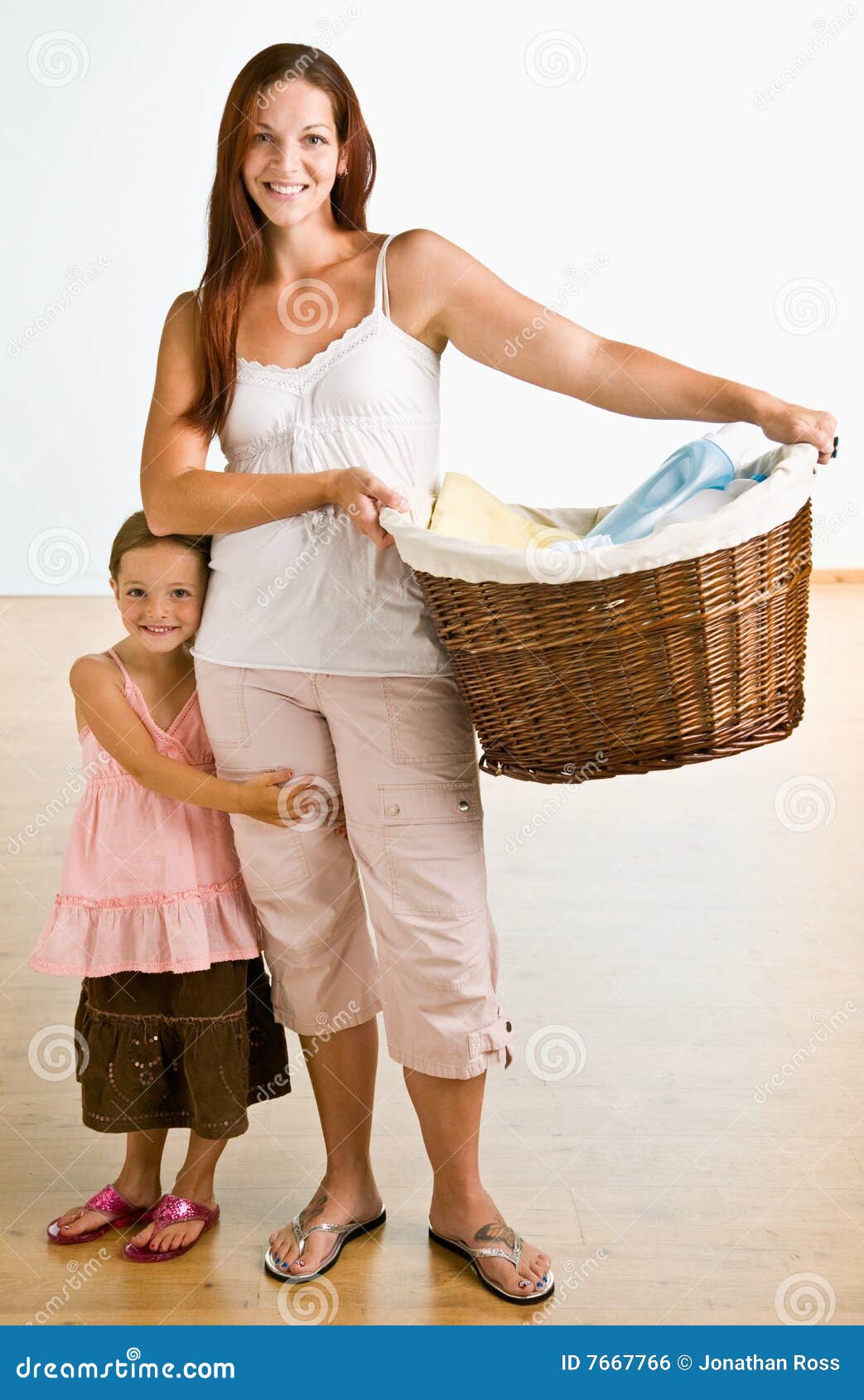 Mother Holding Laundry Basket With Daughter Near Royalty Free Stock