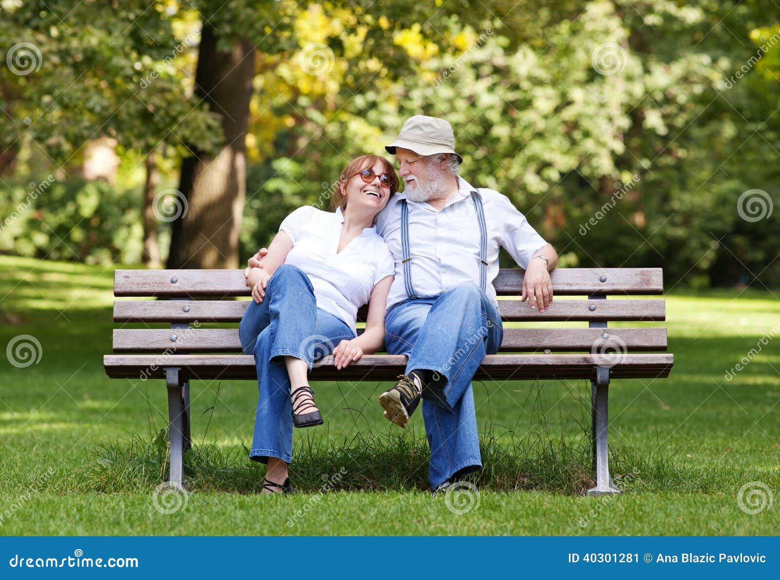Senior Couple Sitting On A Park Bench