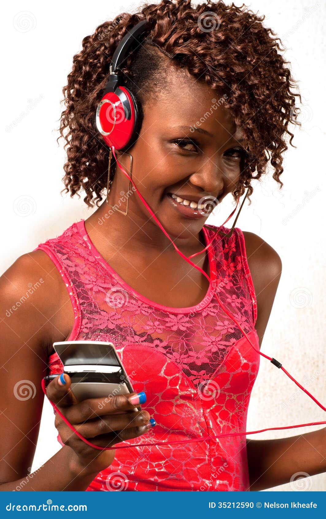 Young African American Woman Listening To Music With Headphones Stock