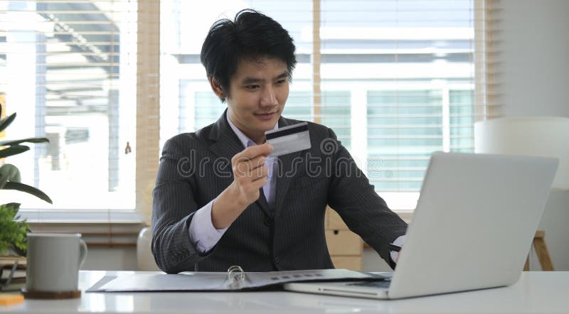 Businessman Holding Credit Card and Using Laptop Computer Stock Photo ...