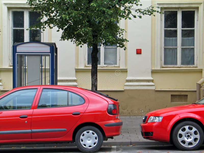 2 cut red cars on parking stock image. Image of phone - 1263555