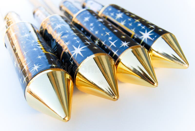 4 Diagonal New Fireworks Rockets with Golden Top Stock Image - Image of ...