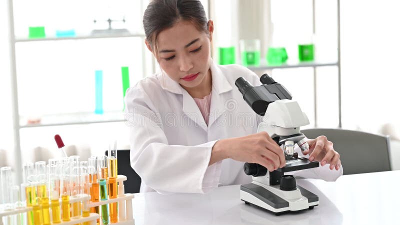 4K Scientist Chemist Drips Examines Drops of Liquid on Glass Slide ...