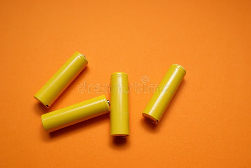 AA Rechargeable Batteries on Orange with Clipping Path. Yellow ...