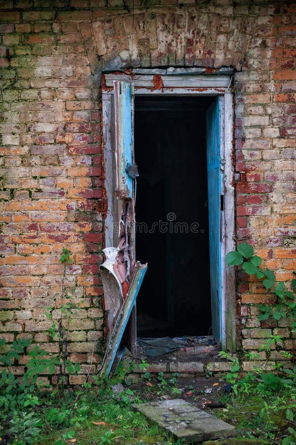 Abandoned Broken Door Leads into a Decayed Building with Brick Walls ...
