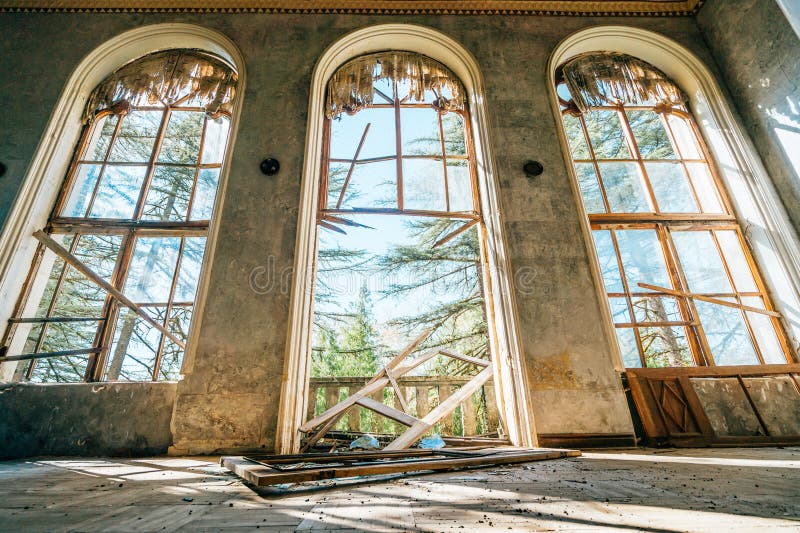 Abandoned Building Interior with Large Broken Arched Windows. Sunlight ...