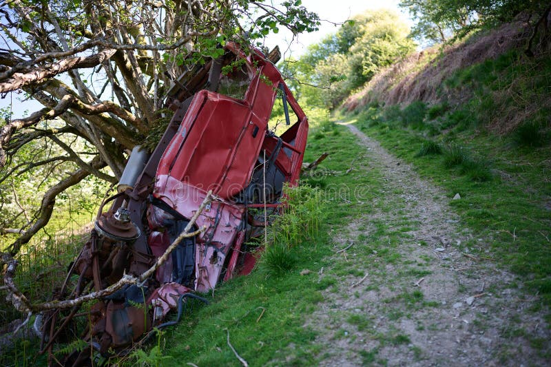 Abandoned Crashed Red Car Overturned by Side of Track in a Tree in ...