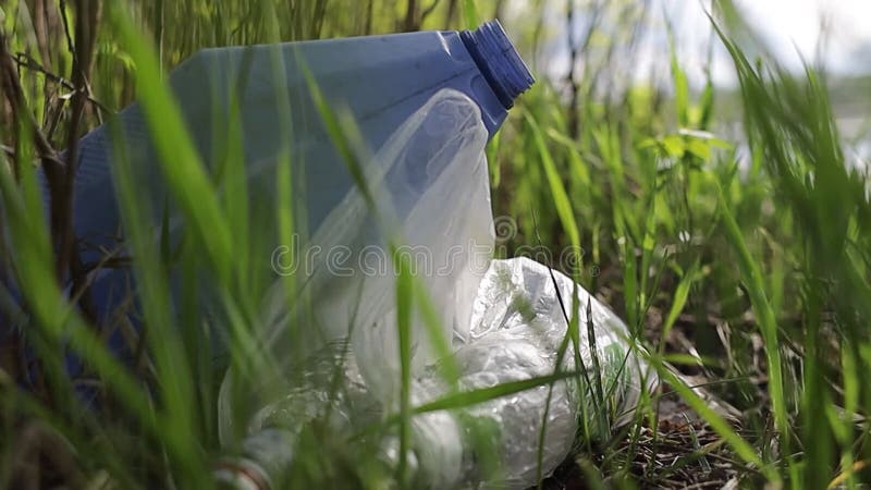 Abandoned Garbage Plastic and Glass Waste in Nature among the Grass ...