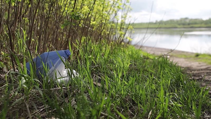 Abandoned Garbage Plastic and Glass Waste in Nature among the Grass ...