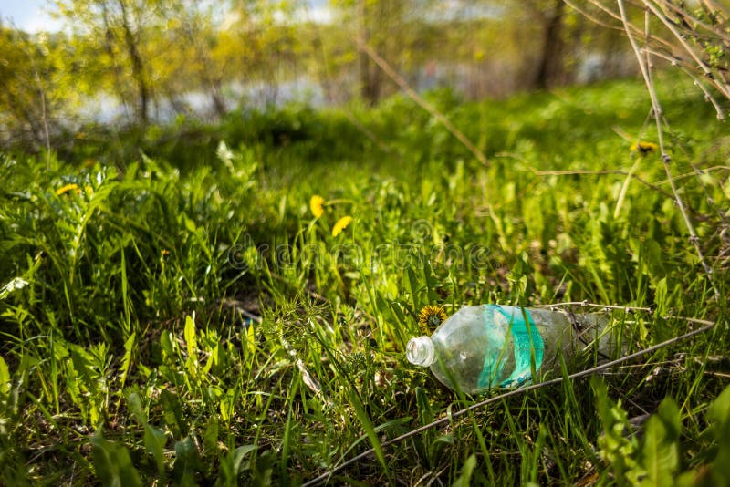 Abandoned Garbage Plastic and Glass Waste in Nature among the Grass ...