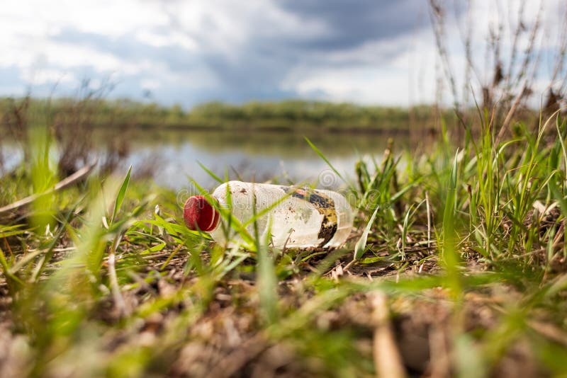 Abandoned Garbage Plastic and Glass Waste in Nature among the Grass ...
