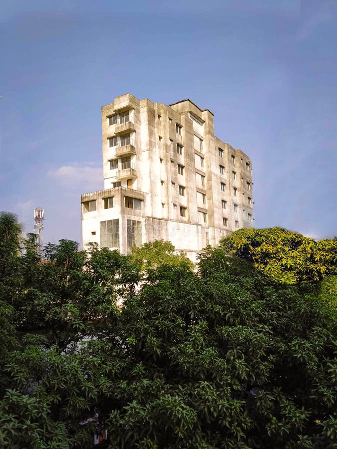 Abandoned High-rise Building Surrounded by Lush Greenery. Stock Image ...