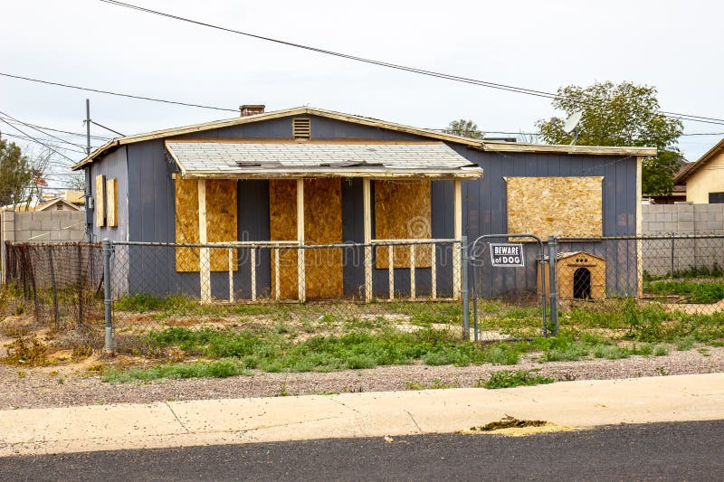 Abandoned Home with Boarded Up Windows and Doors Stock Photo - Image of ...