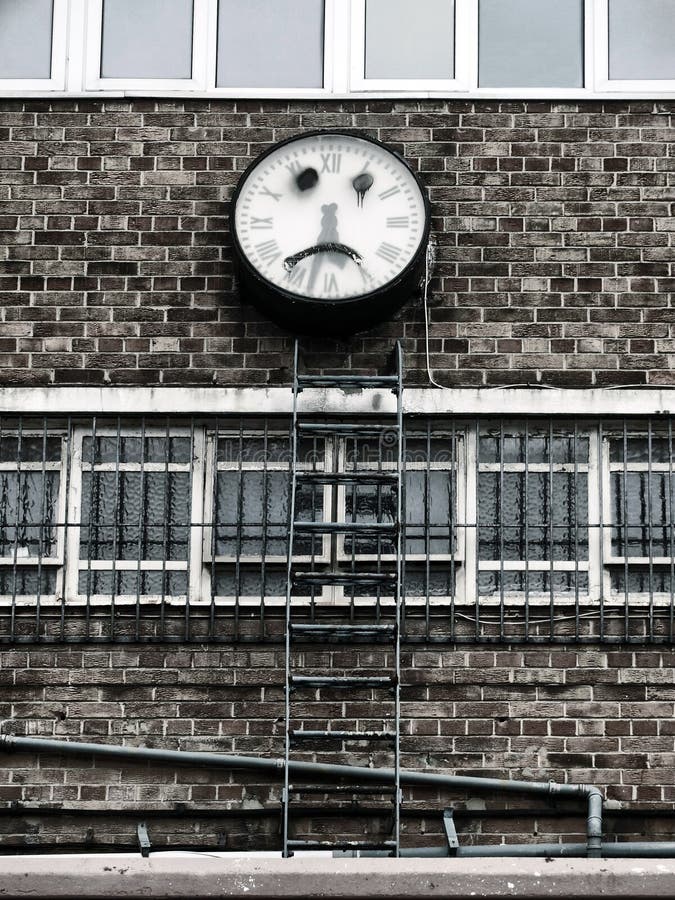 An Abandoned Industrial Building with Sad Face Painted Over a Clock in ...