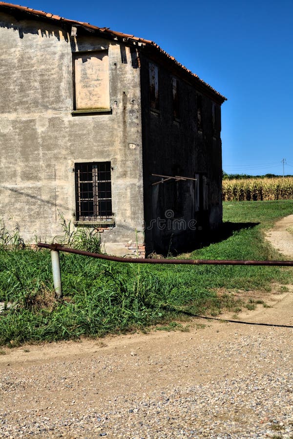 Abandoned Mansion with a Barn Surrounded by Corn Fields in the Italian ...