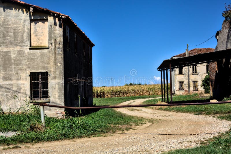 Abandoned Mansion with a Barn Surrounded by Corn Fields in the Italian ...