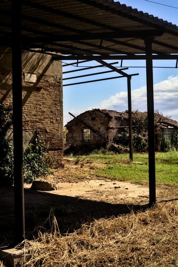 Abandoned Mansion with a Barn Surrounded by Corn Fields in the Italian ...