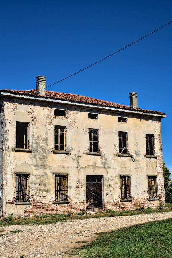 Abandoned Mansion with a Barn Surrounded by Corn Fields in the Italian ...
