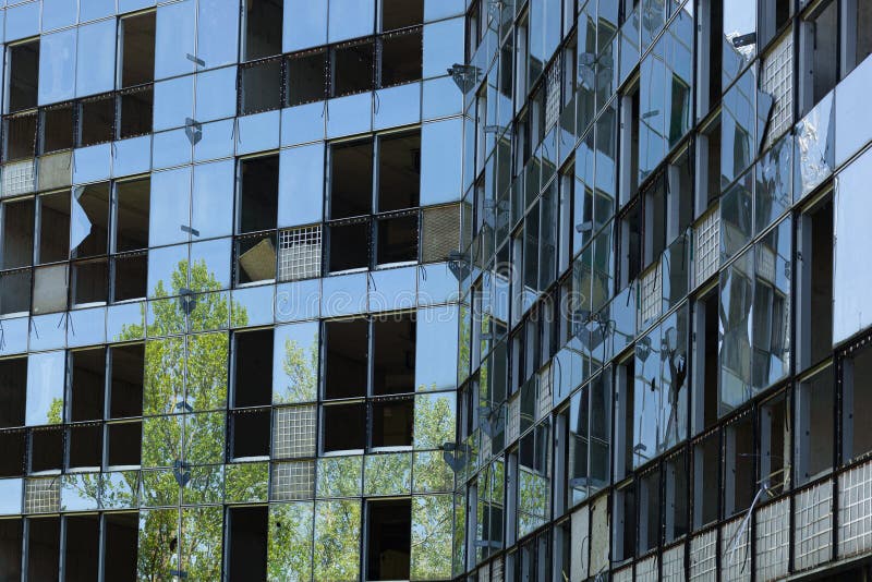 Abandoned Modern Glass Building with Broken Windows and Reflection of ...