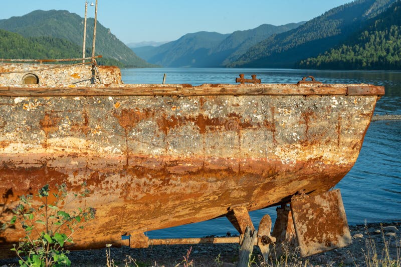 The Abandoned Old Rusty Ship Placing on the Coast of Lake Stock Photo ...