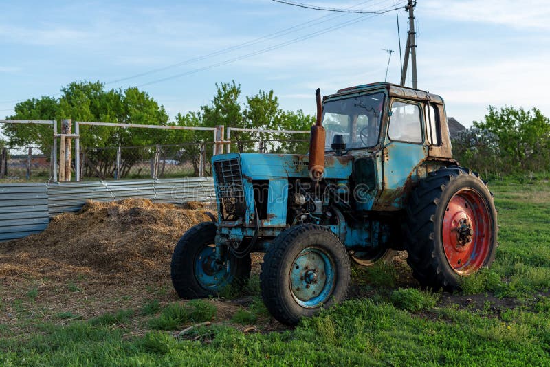 Abandoned Old Tractor in the Village. Blue Tractor with Red Wheel Stock ...