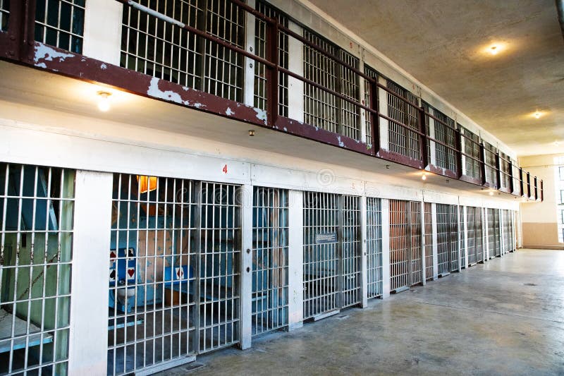 Abandoned Prison Corridor with Metal Cell Doors and Dim Lighting Stock ...