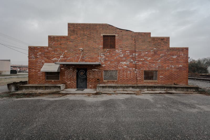 Abandoned Red Brick Building with Angular Roof on Overcast Day in the ...