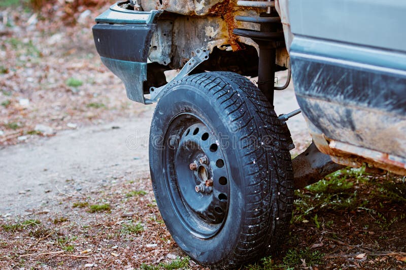Abandoned Rusty Fragment of a Car with a Wheel. Levers, Strut, Spring ...