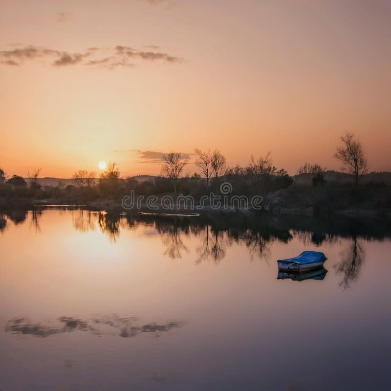 Abandoned Small Boat in the Water on a Wonderful Sunset Evening Stock ...