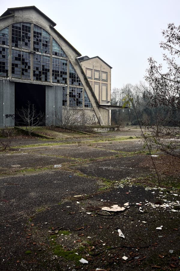 Abandoned Warehouse with Broken Windows in a Park on a Cloudy Day in ...