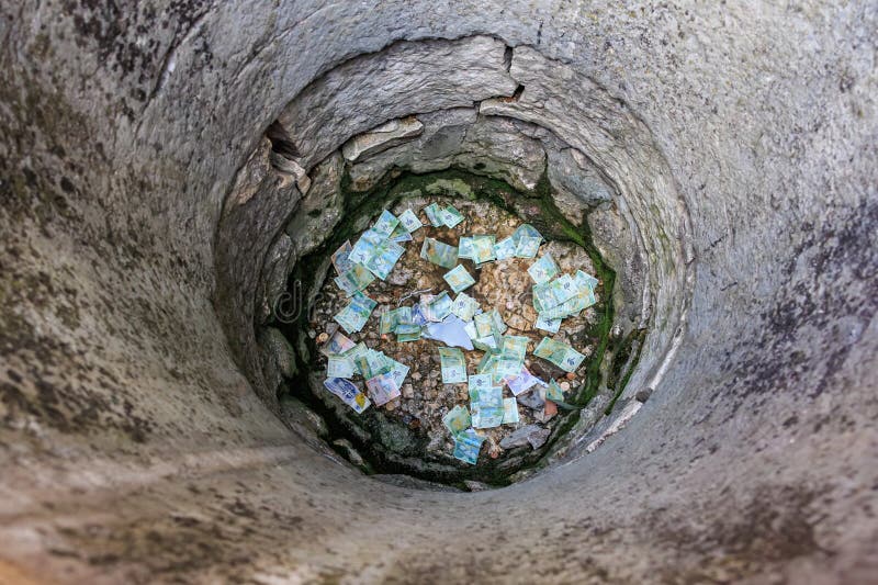 Abandoned Well Filled with Scattered Currency Notes in a Stone ...