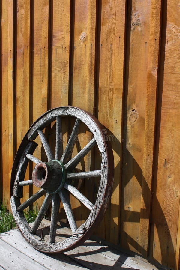 Old Rustic Wagon Wheel beside a Red Barn. Stock Image - Image of ...