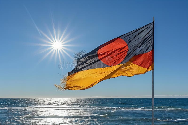 The Aboriginal Flag Flying in Front of the Ocean on a Clear Blue Sky, Bright and Sunny Day Stock ...