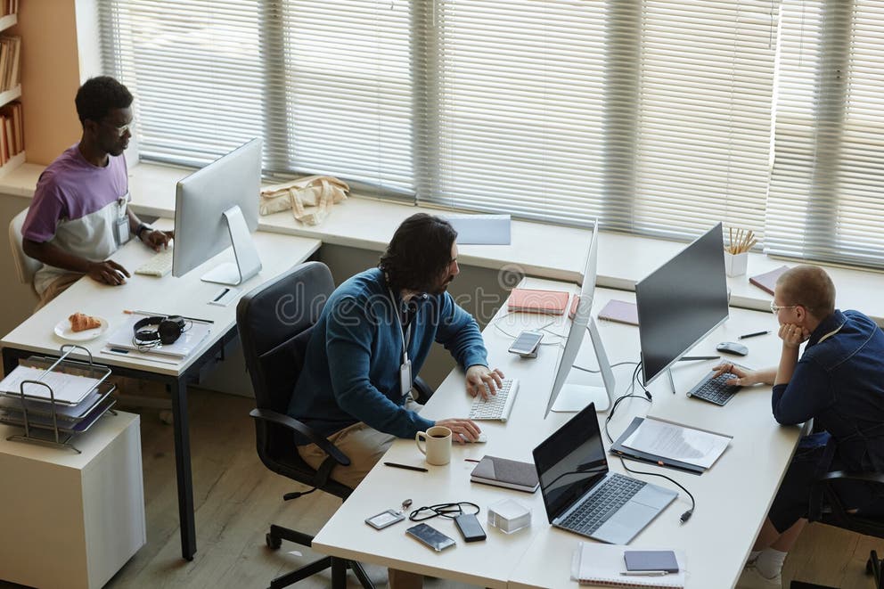 Above Angle of Several Intercultural it Engineers Sitting in Front of ...