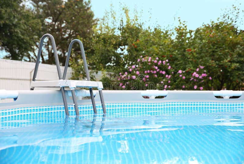 Above Ground Swimming Pool with Handrails and Ladder in Backyard Stock ...