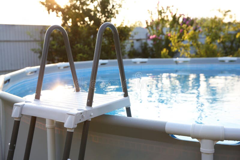 Above Ground Swimming Pool with Ladder Outdoors on Sunny Day Stock ...