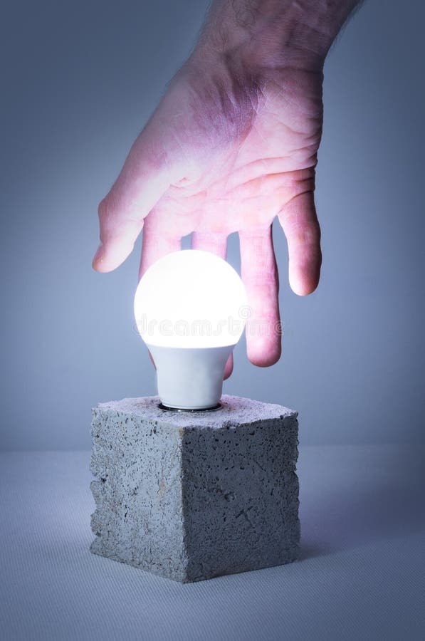 From Above, a Hand Reaches for a Lamp Emitting Light Stock Photo ...