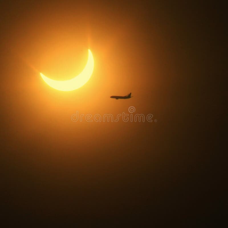 Above the Shadows: Aircraft Soaring through a Solar Eclipse Stock Photo ...