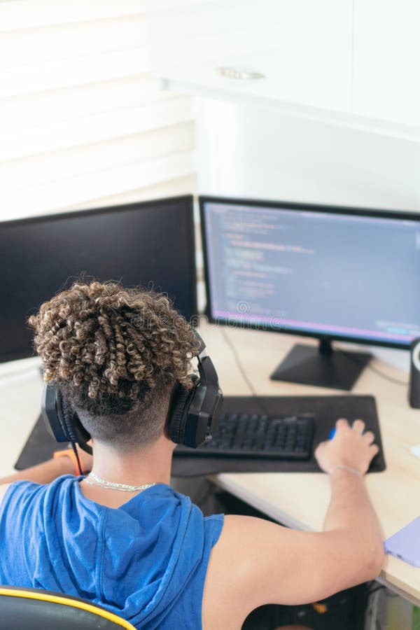 From Above Software Engineer Sitting At Desk And Typing On Computer Keyboard While Creating