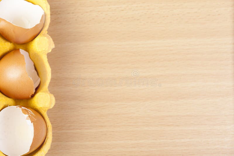 Above View of Broken Egg Shells in a Yellow Egg Carton Stock Photo ...