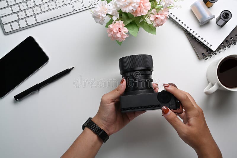 Female Photographer Holding Digital Camera on Her Workspace. Stock ...
