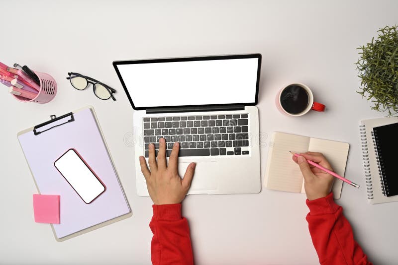 Man Using Laptop Computer and Making Notes on Notepad. Stock Image ...