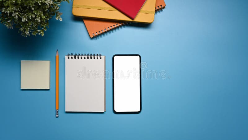 Above View Smart Phone, Notepad and Sticky Note on Blue Background ...