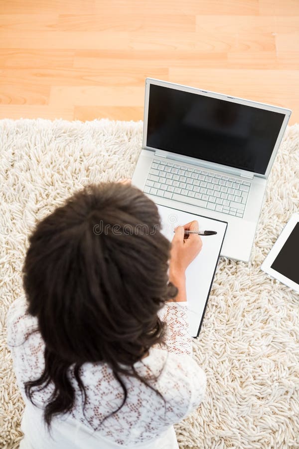 Above View of a Woman Writing Note while Using Her Laptop Stock Photo ...
