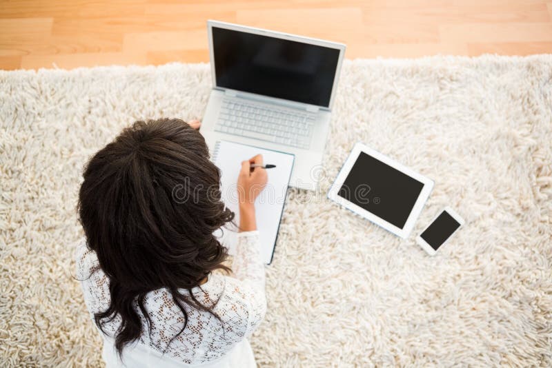 Above View of a Woman Writing Note while Using Her Laptop Stock Photo ...