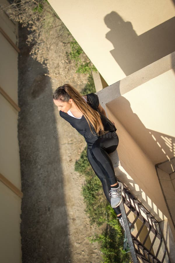 Above View of Young Woman Sitting on Wall and Looking Away Stock Photo ...