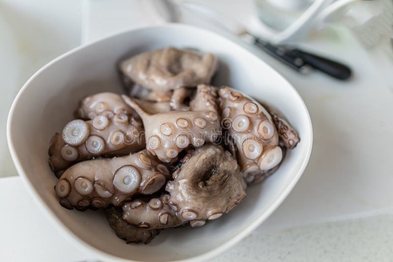 From Above of Whole Raw Octopus Boiling in Pot on Modern Black ...